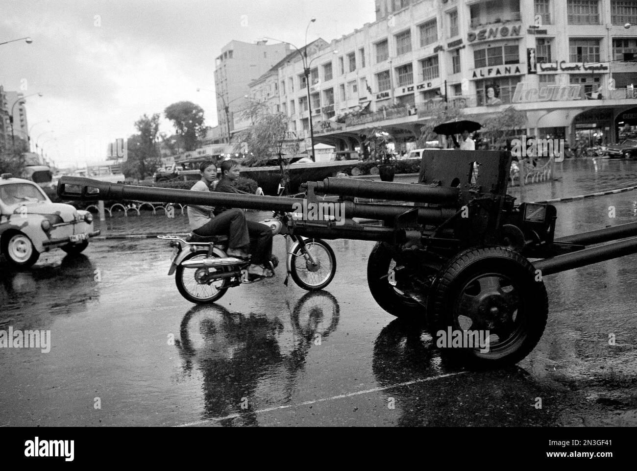 Two Saigonese look at captured Russian-built 76mm Howitzer which is ...