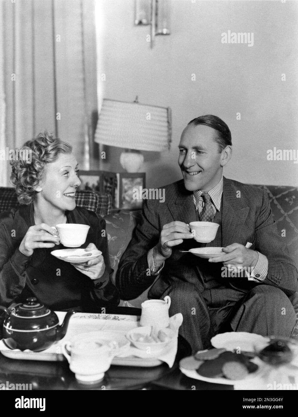 Jack Hulbert, the famous comedian, partaking of tea with his equally ...