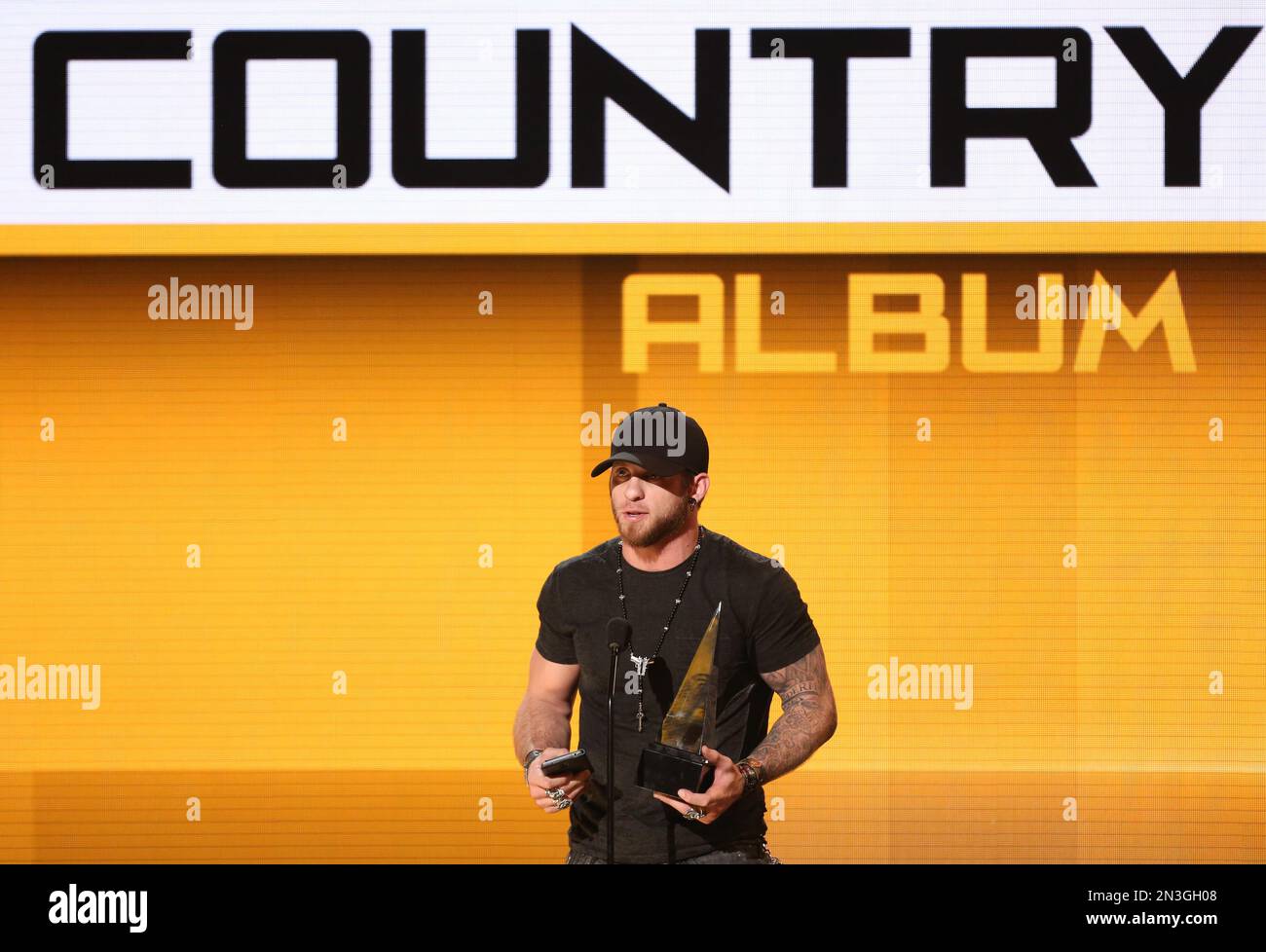 Brantley Gilbert accepts the award for favorite country album for “Just ...