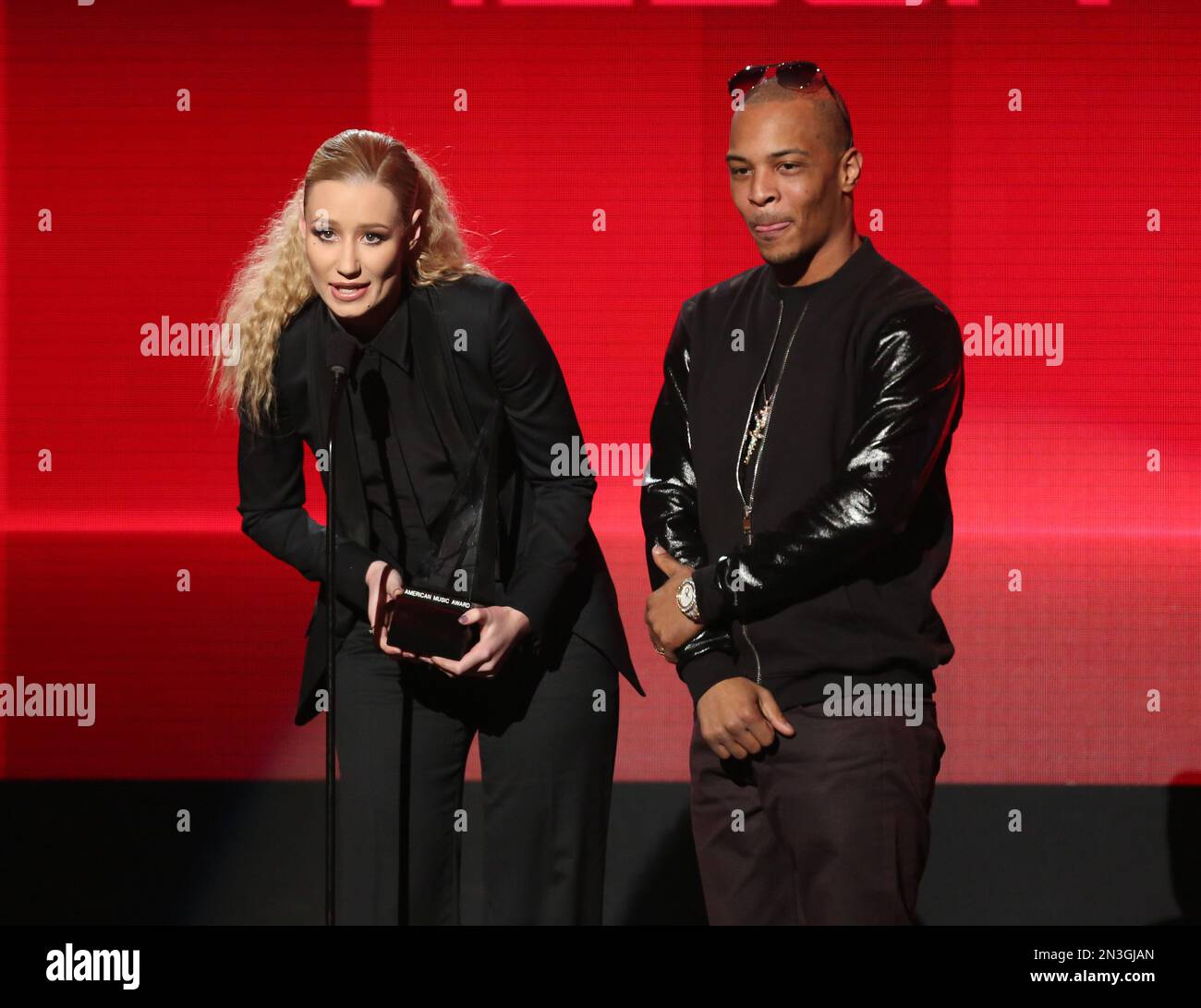 Iggy Azalea, left, and T.I. accept the award for favorite rap/hip-hop ...