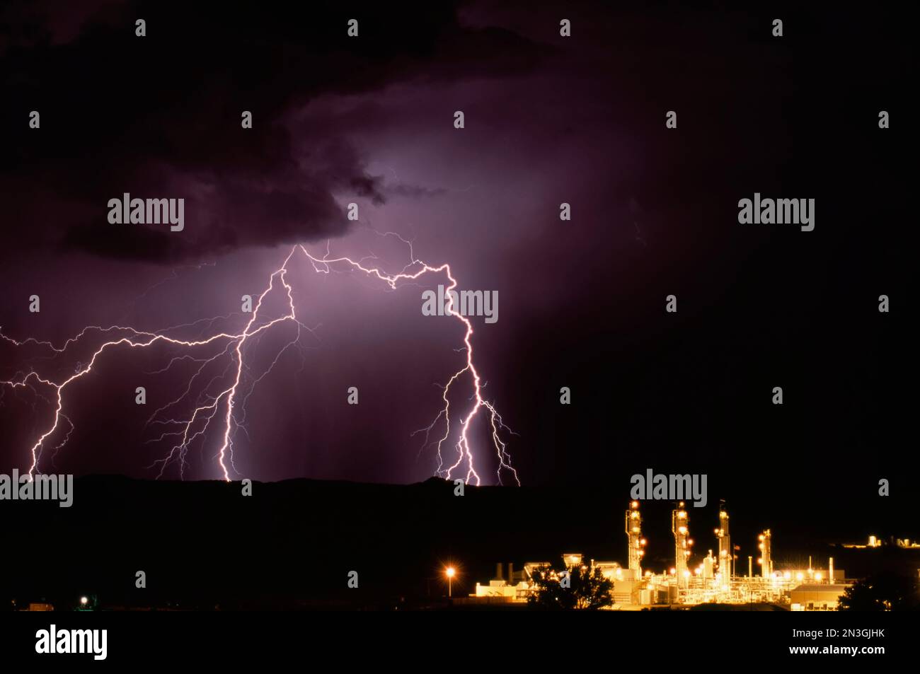 Lightning lights the night sky above a gas refinery; Bloomfield, New ...