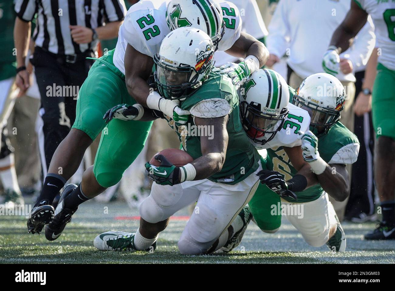 UAB running back Jordan Howard is brought down by Marshall linebacker D ...
