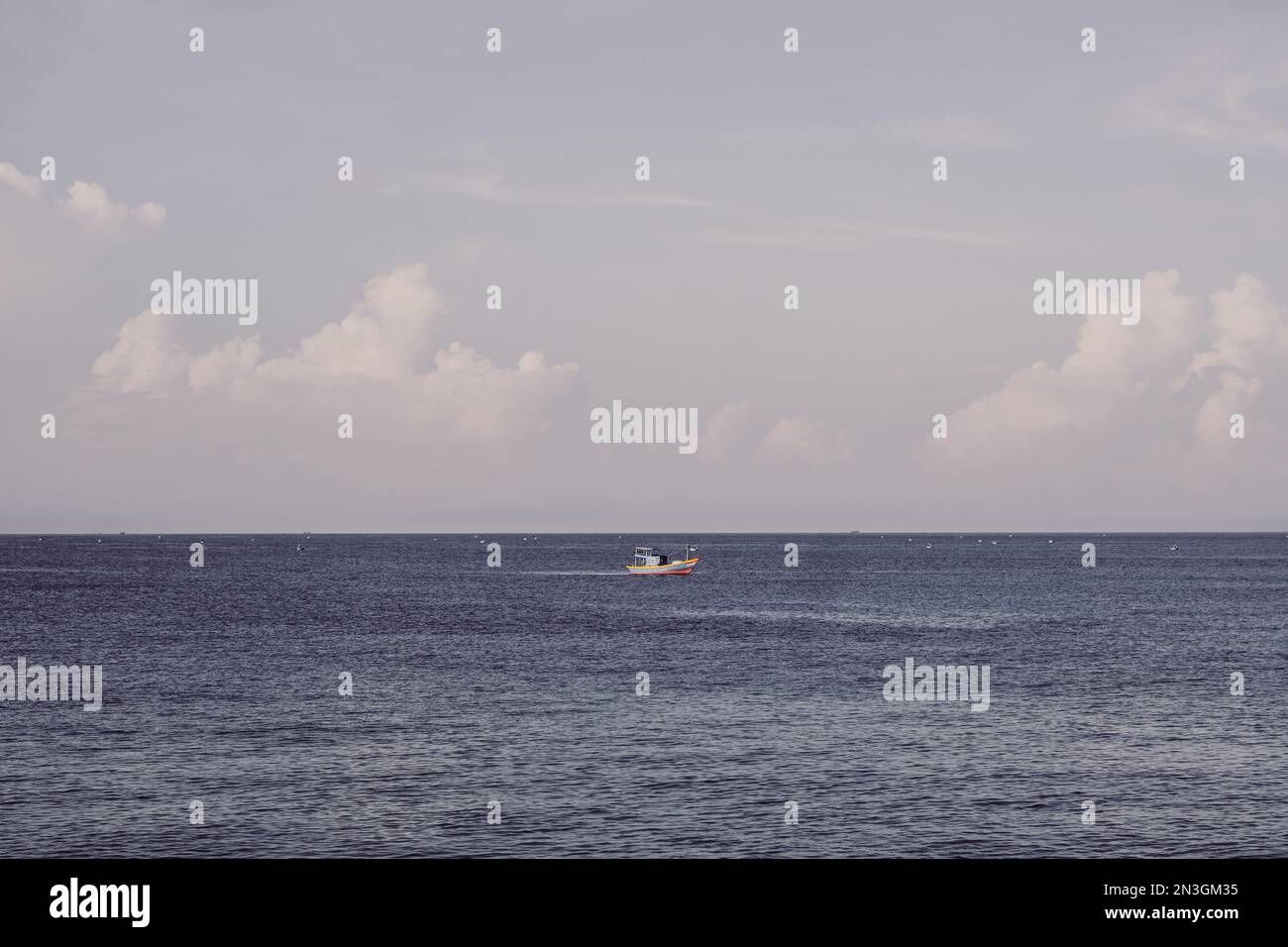 Sea sky cumulus cloud landscape view background. Calm water alone fishing boat. Destination aim ...