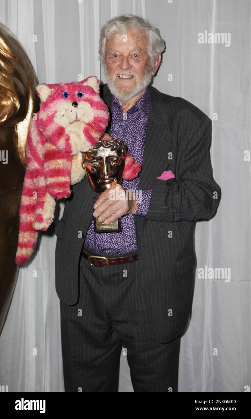 Peter Firmin poses with his creation 'Bagpuss' and his Special Award ...