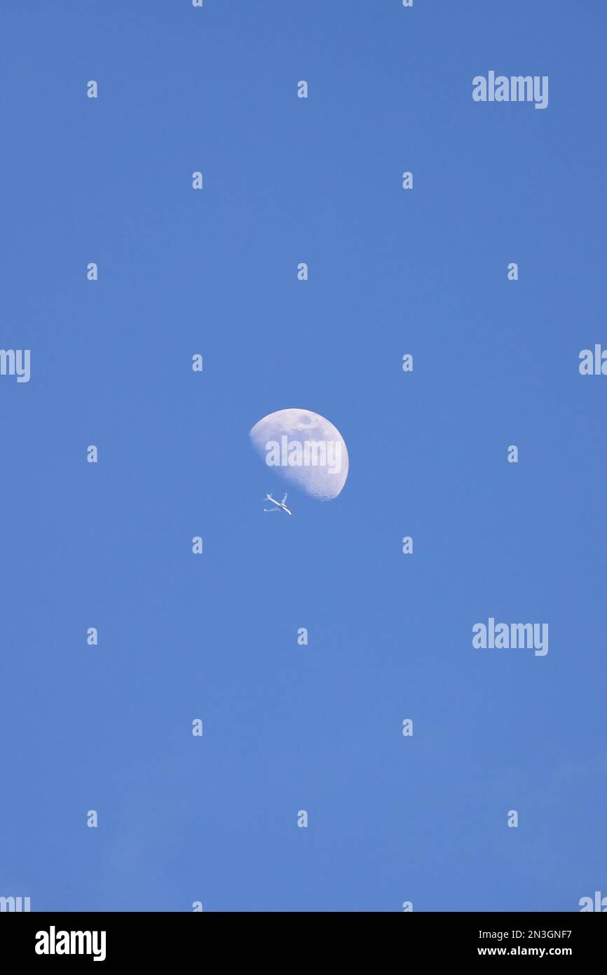 Airliner flying under moon hi-res stock photography and images - Alamy