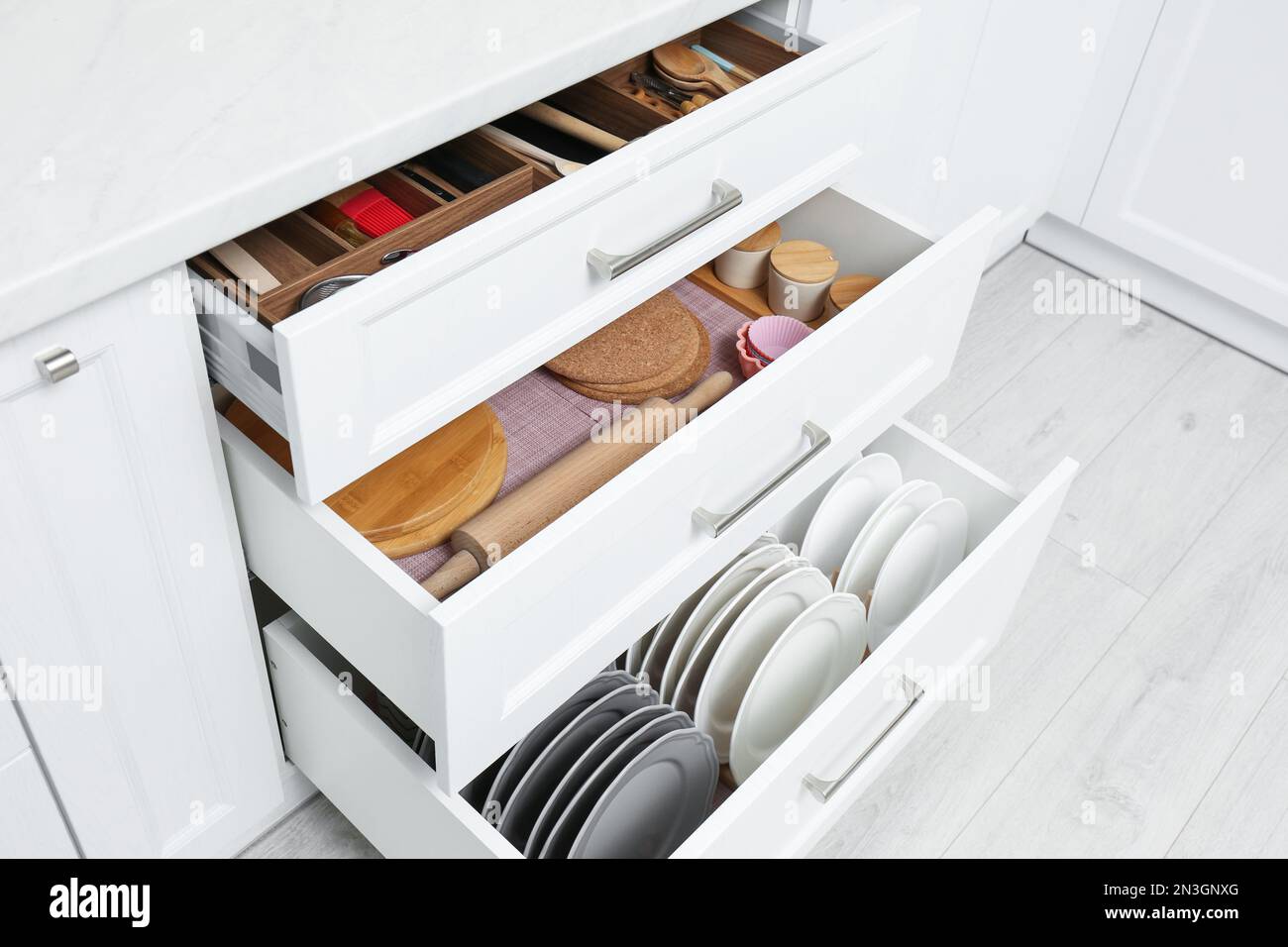 Open drawers with cutlery and utensils indoors. Order in kitchen Stock ...