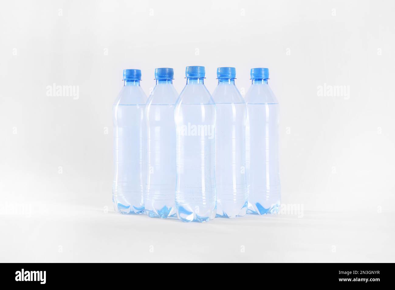 Plastic bottles with pure water on white background Stock Photo - Alamy