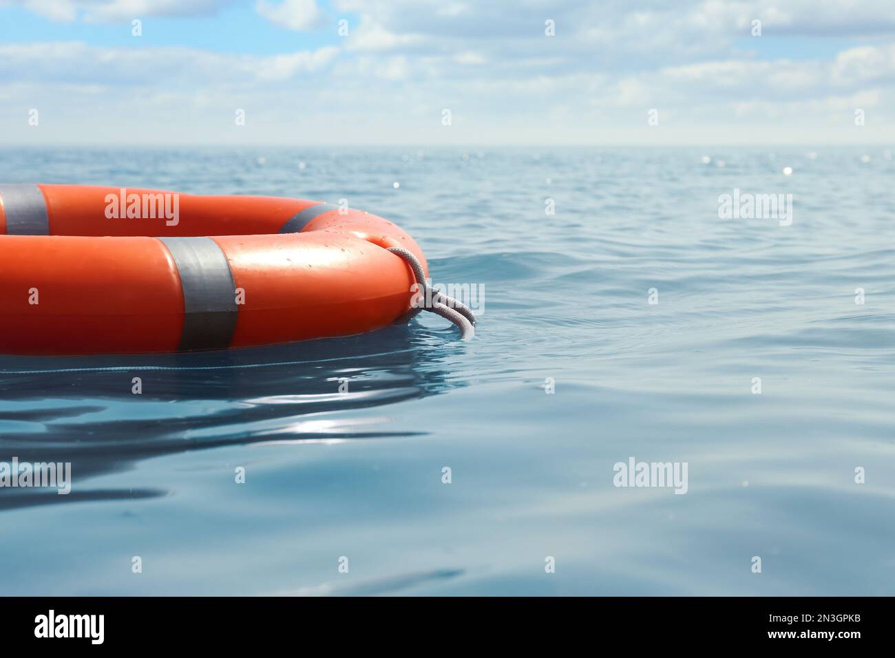 Orange life buoy floating in sea. Emergency rescue equipment Stock ...