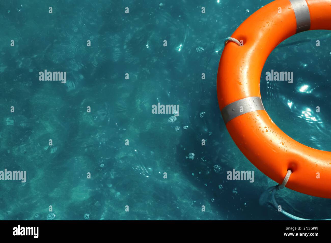 Orange life buoy floating in sea, above view. Emergency rescue ...