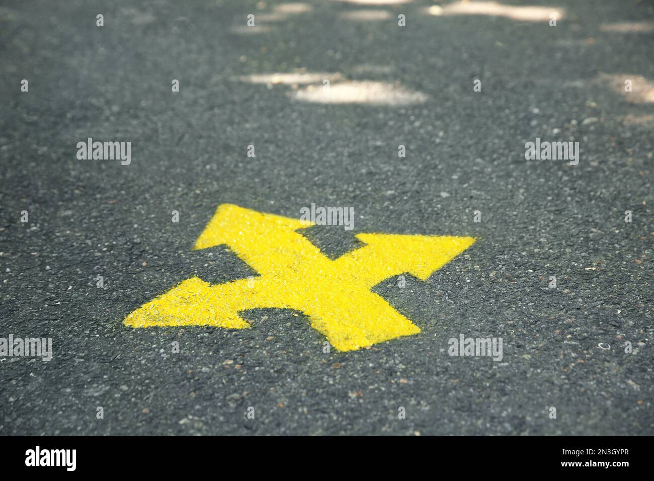 Bright yellow arrows painted on asphalt road Stock Photo - Alamy