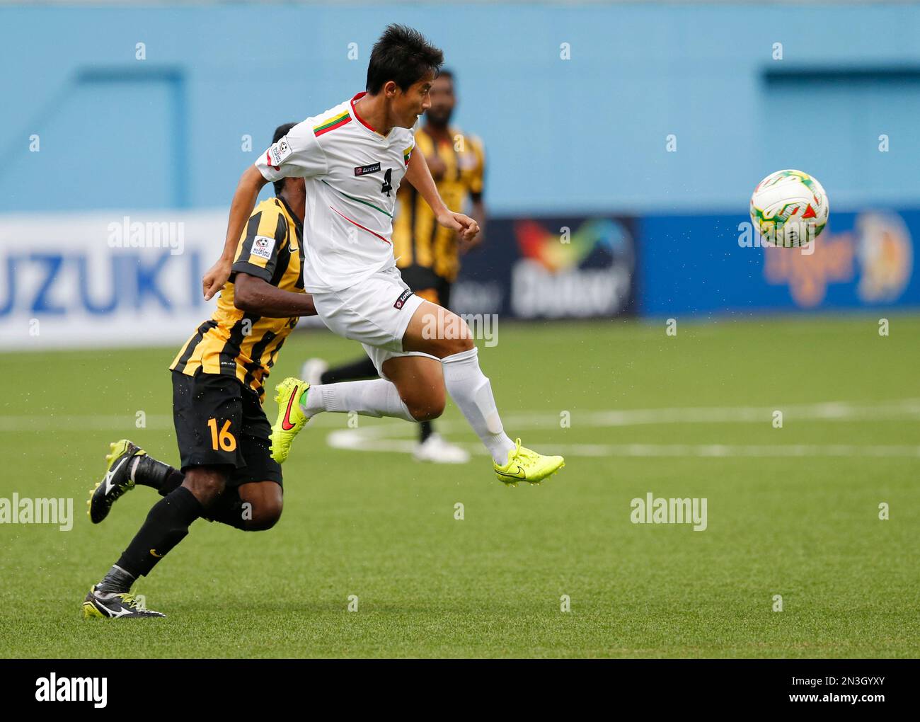 Myanmar's David Htan kicks the ball down field as Malaysia's ...