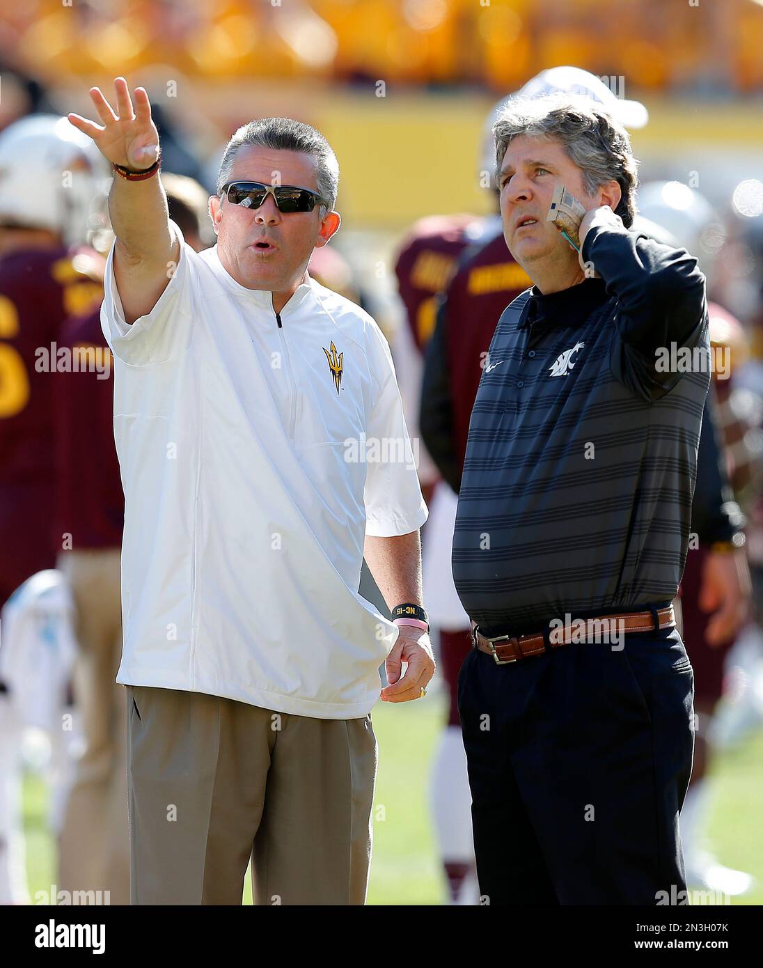 Arizona State head coach Todd Graham, left, talks to Washington State ...