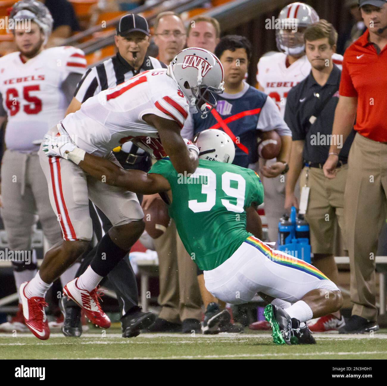 UNLV wide receiver Devante Davis (81) is wrapped up by Hawaii defensive ...