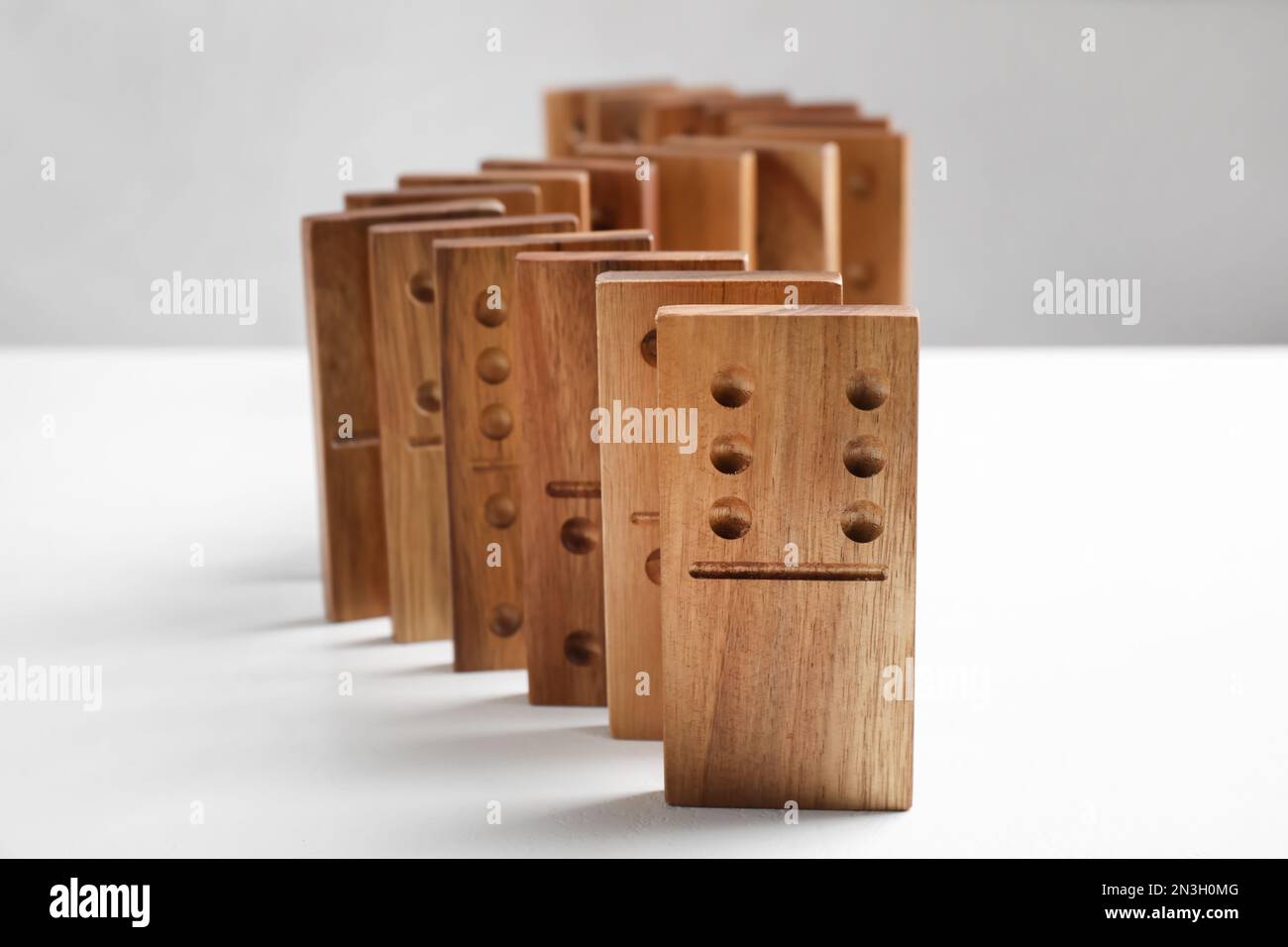 Beautiful wooden dominoes on white table, closeup Stock Photo - Alamy