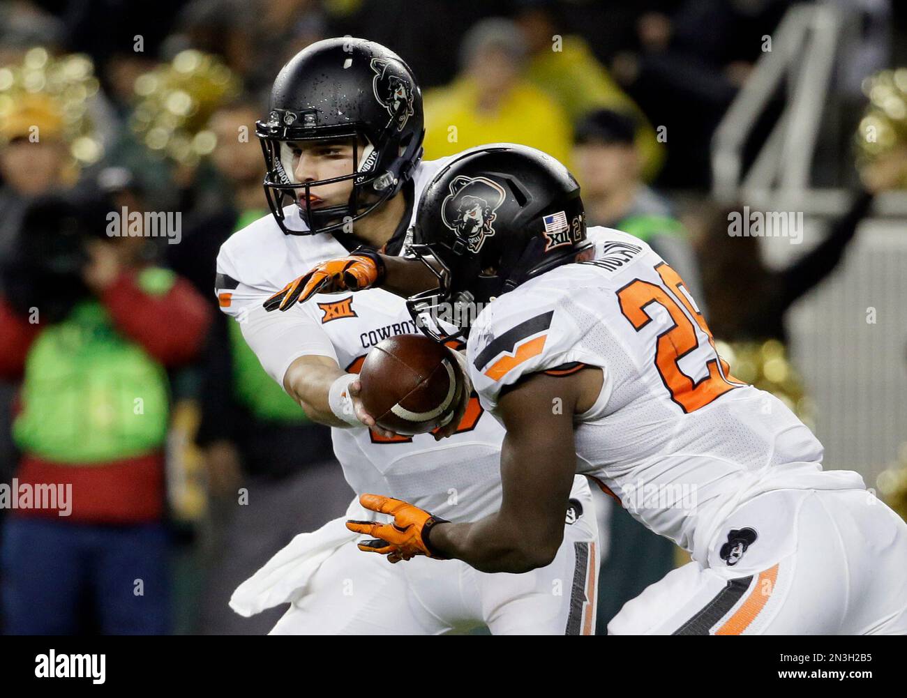 Oklahoma State quarterback Mason Rudolph (10) hands the ball off to ...