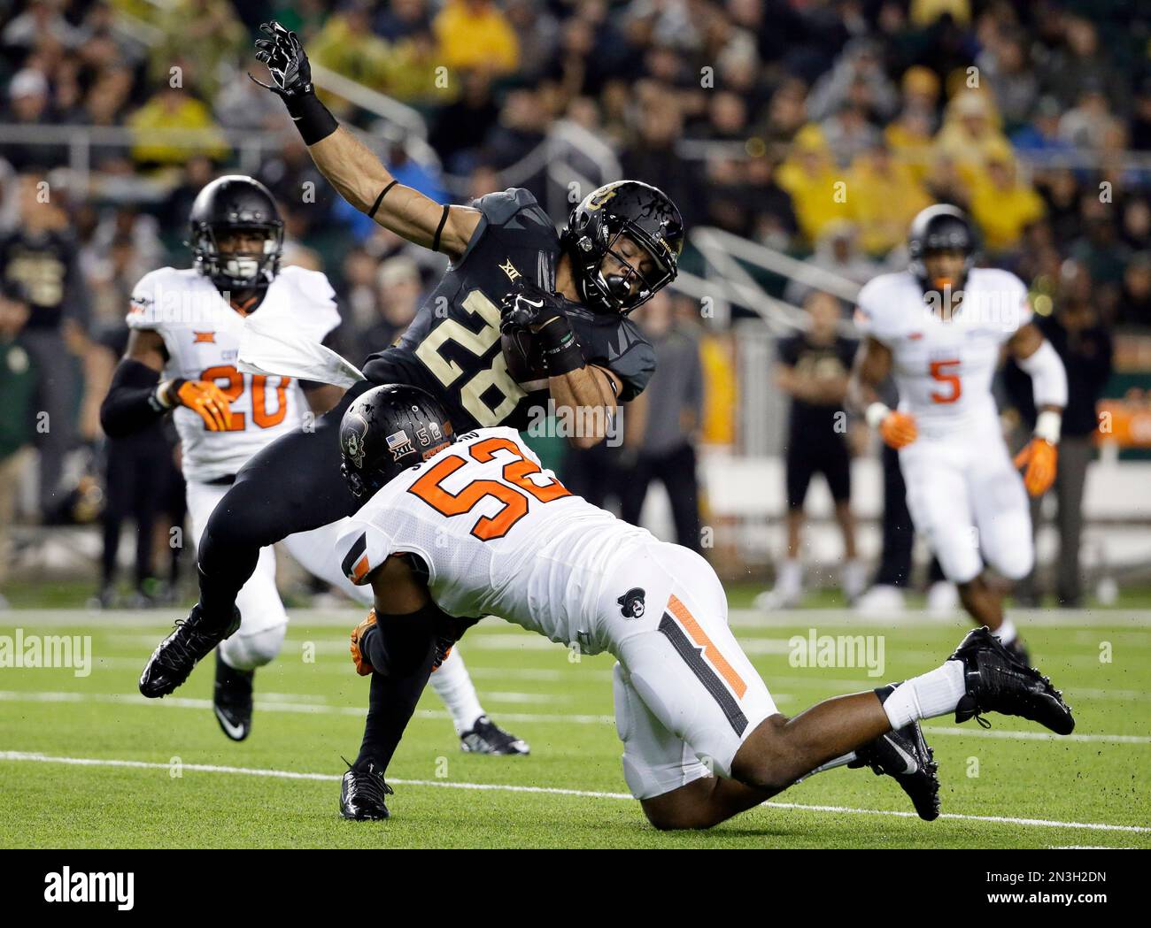 Oklahoma State linebacker Ryan Simmons (52) makes an open field tackle ...