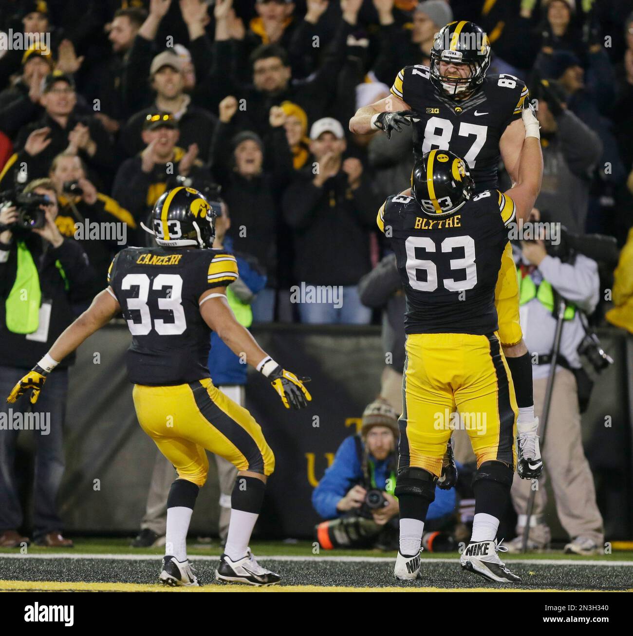 Iowa tight end Jake Duzey (87) celebrates with teammates Jordan Canzeri ...