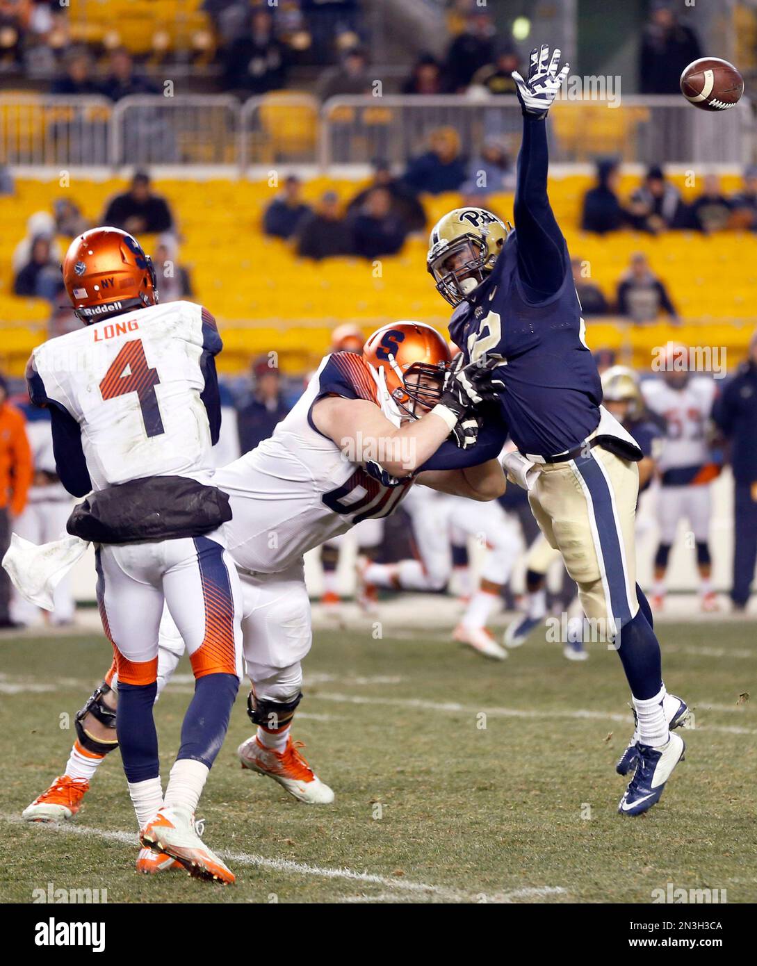 Syracuse quarterback AJ Long (4) gets a pass over Pittsburgh defensive ...