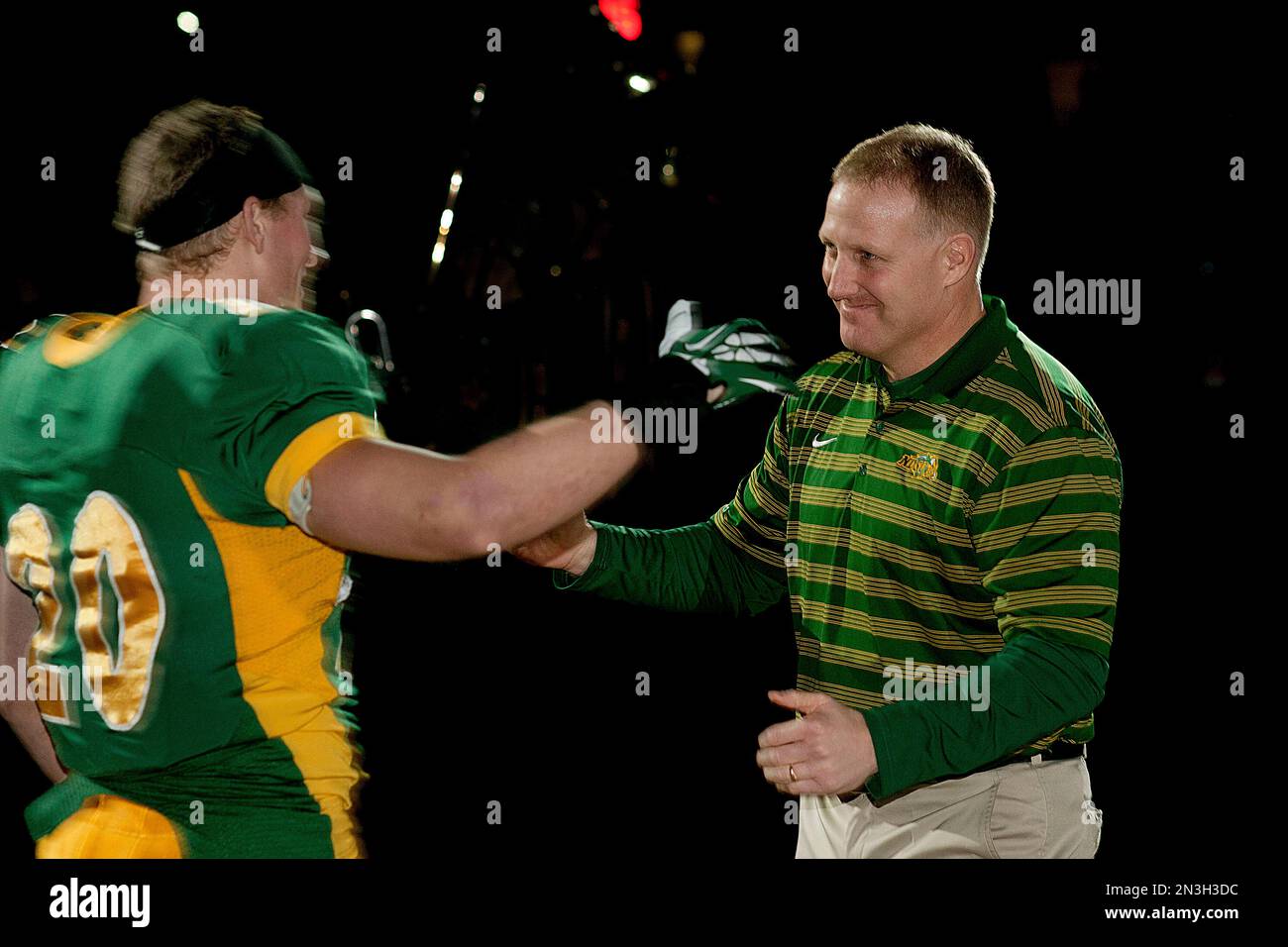 North Dakota State coach Chris Klieman greets strong safety Colten ...