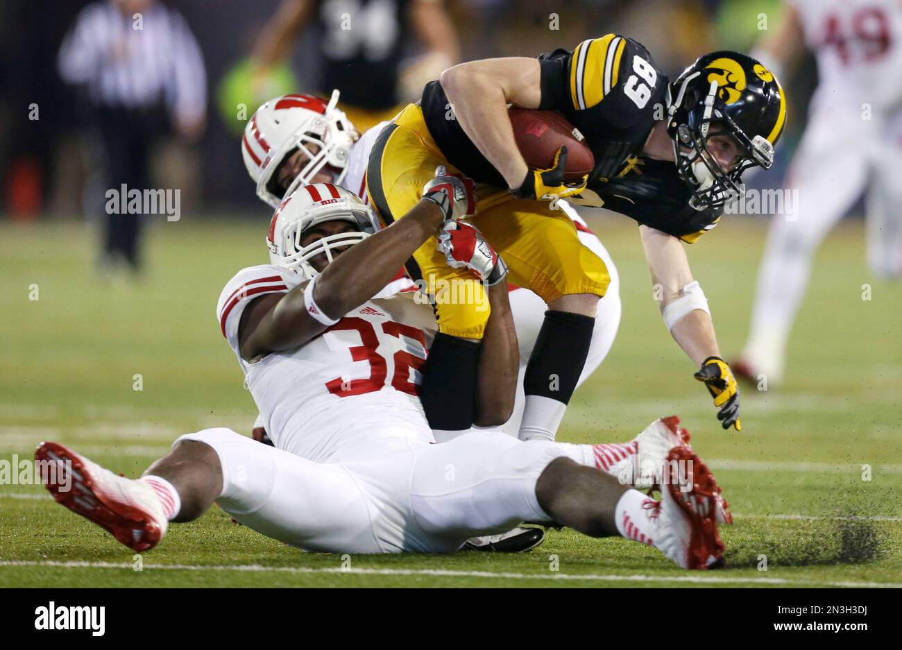 Wisconsin linebacker Leon Jacobs (32) tackles Iowa wide receiver Matt ...