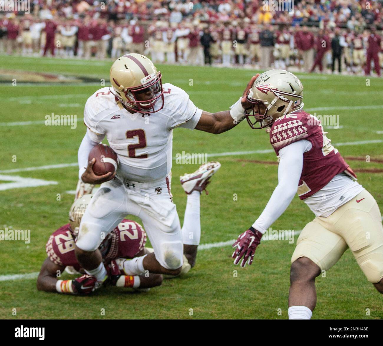Boston College quarterback Tyler Murphy, center, gets sacked by Florida ...