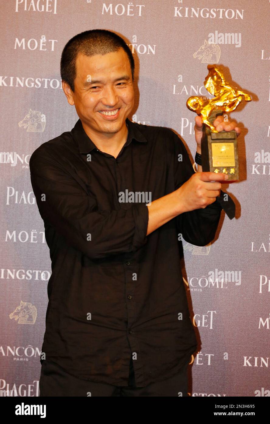 Chinese director Lou Ye holds his award and poses for media for Best ...