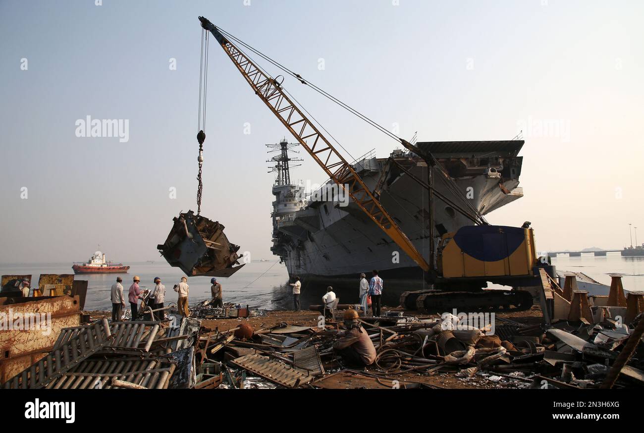 Workers dismantle India's first aircraft carrier INS Vikrant at a ship ...