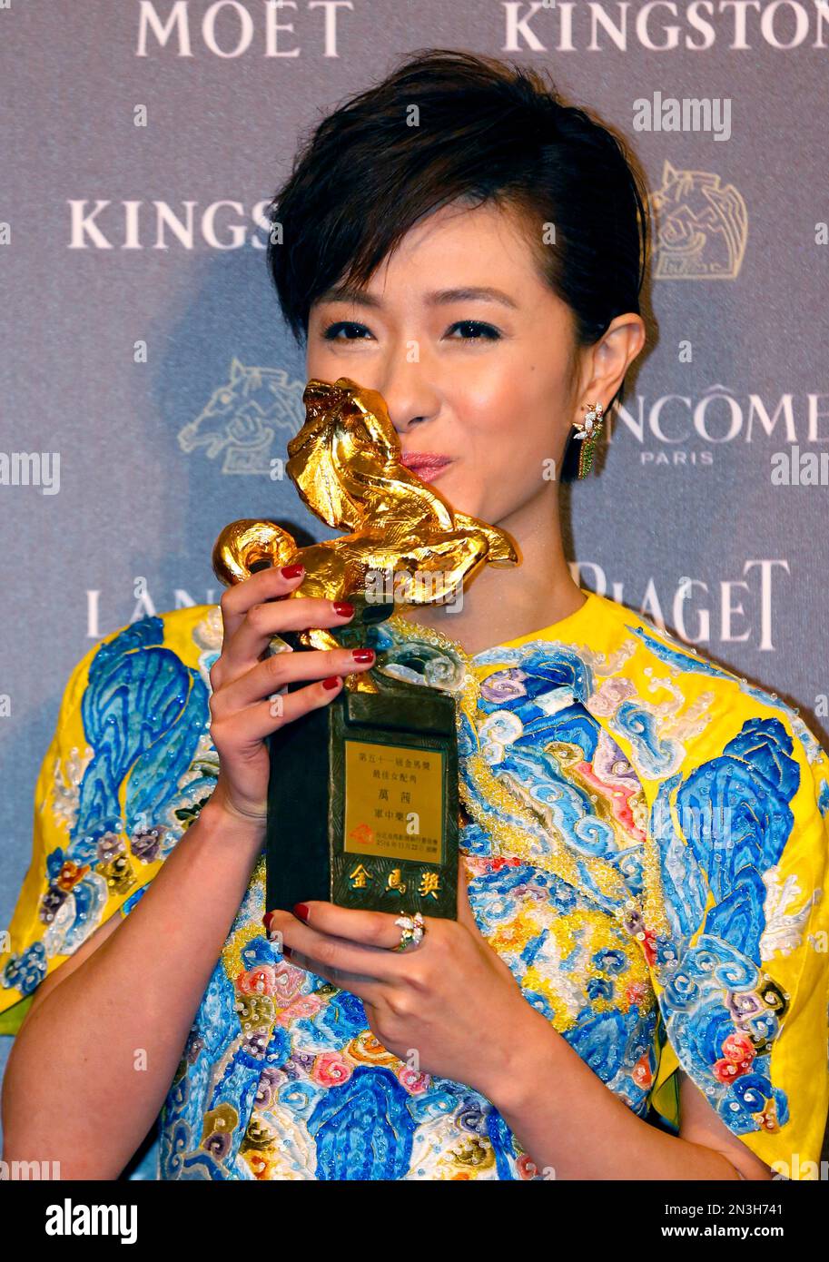 Taiwanese actress Regina Wan kisses her trophy for Best Supporting ...