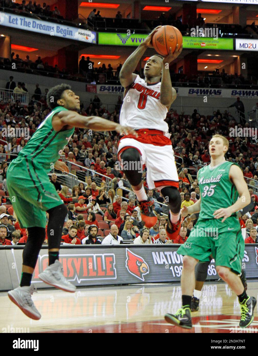 Louisville guard Terry Rozier (0) attempts to shoot over Marshall's ...