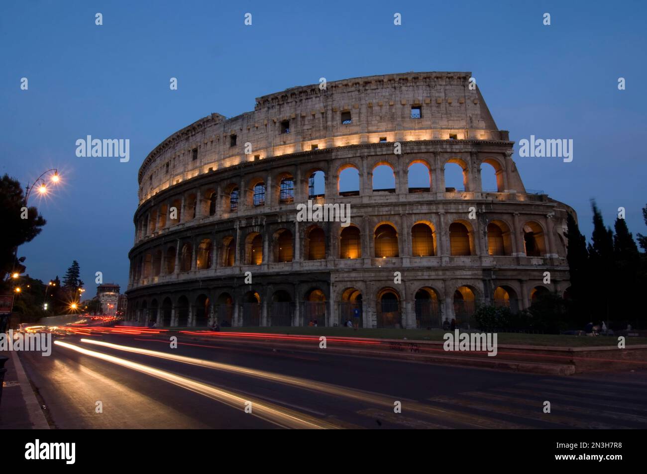 Traffic goes by the Colosseum at night; Rome, Lazio, Italy Stock Photo ...