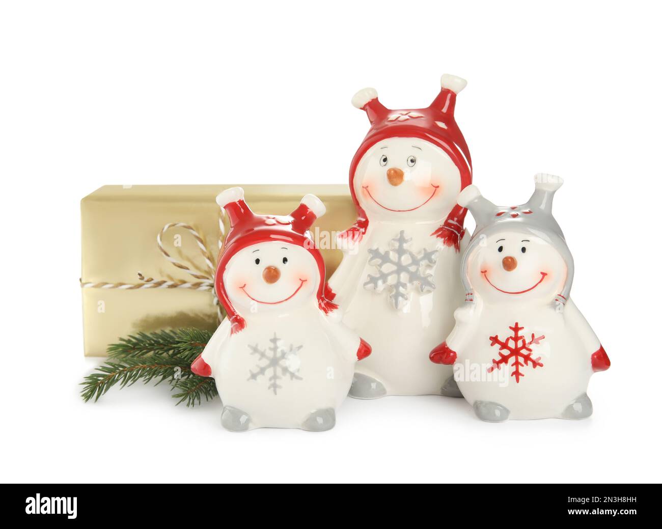 Christmas composition with decorative snowmen and gift box on white ...