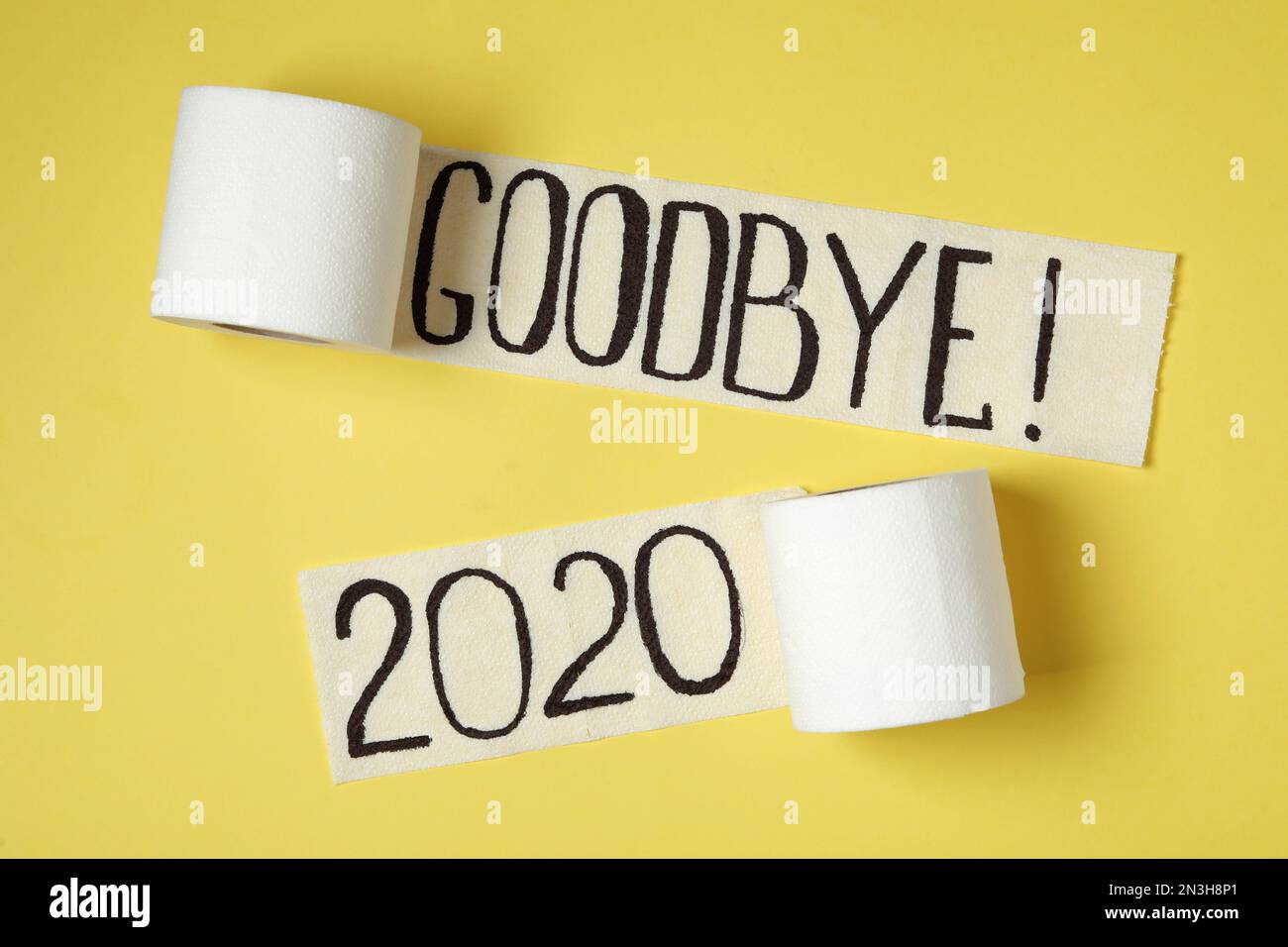 Toilet paper with text Goodbye 2020 on yellow background, flat lay ...
