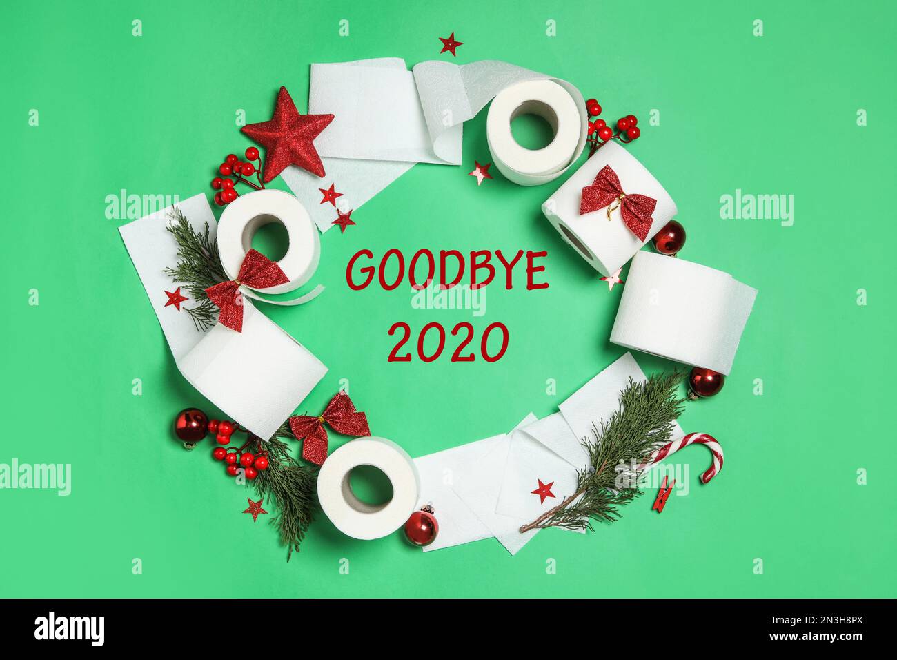 Flat lay composition with text Goodbye 2020 and toilet paper on green ...