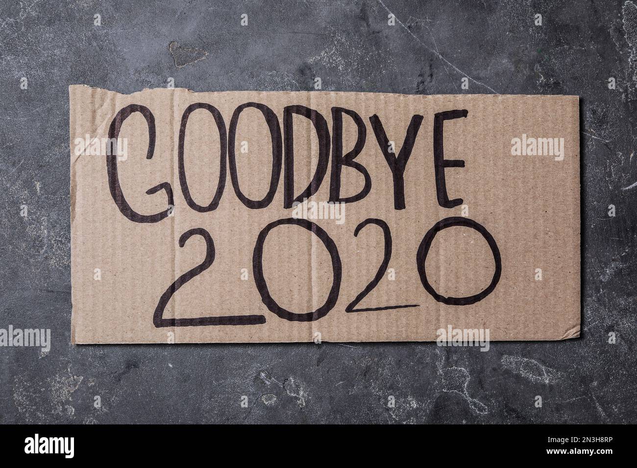Cardboard with text Goodbye 2020 on grey stone background, top view ...