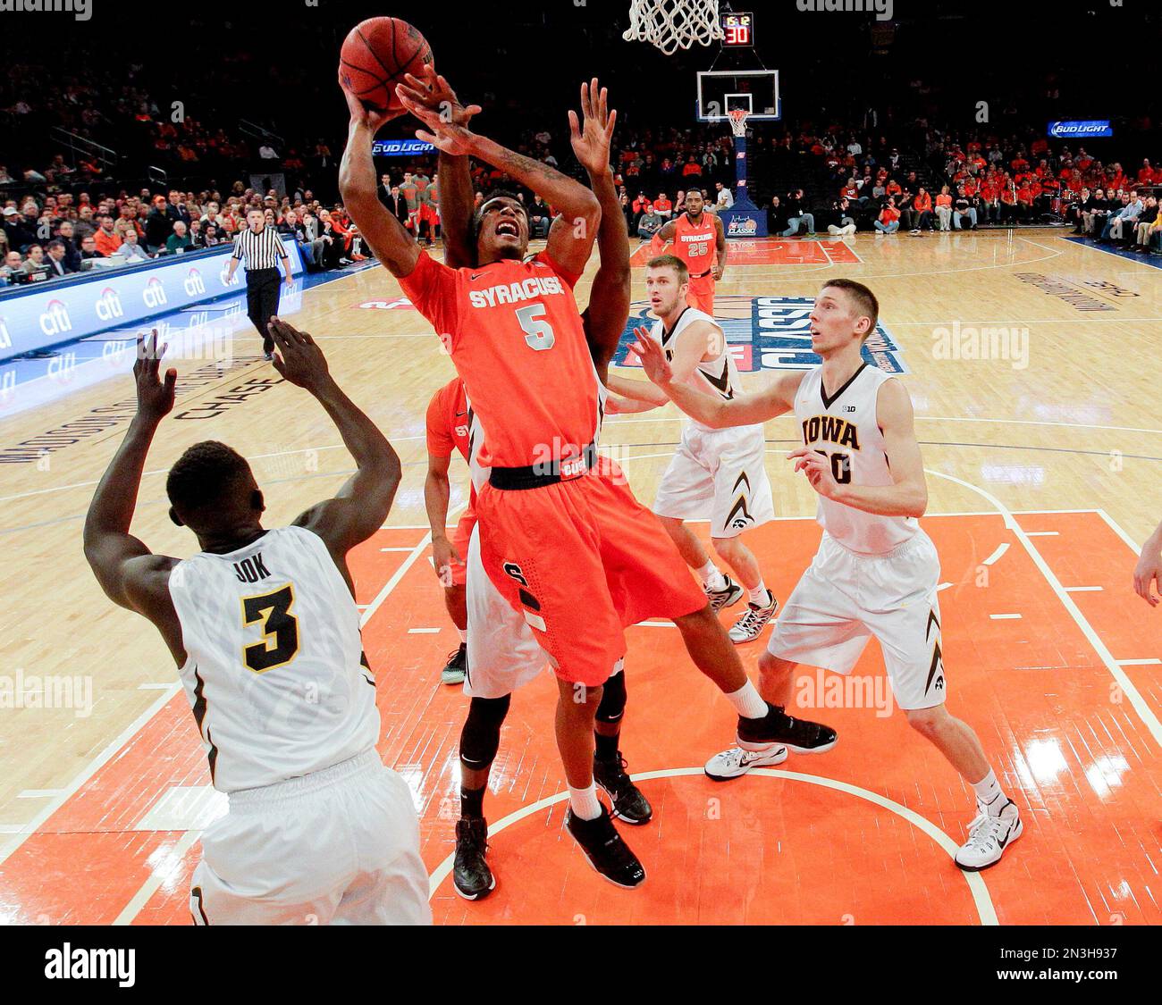 Syracuse's Chris McCullough (5) drives past Iowa's Jarrod Uthoff, right ...