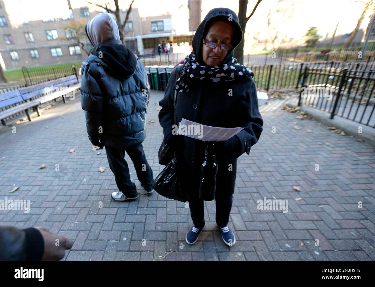 A woman reads a paper with photographs of people allegedly killed by ...