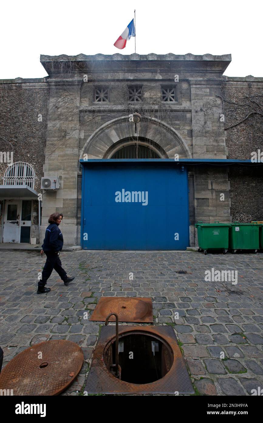 A security guard walks in the prison's entrance courtyard of Parisâ ...