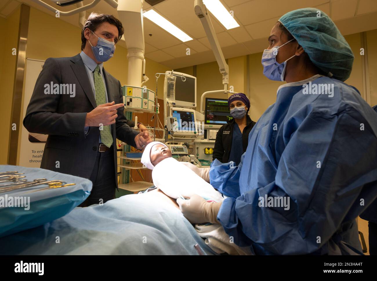 Prime Minister Justin Trudeau, left, speaks with Resident Physician Dr ...