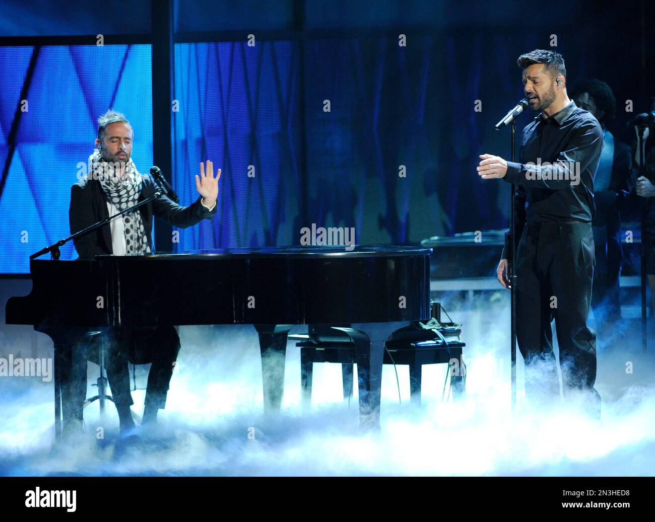Mario Domm, of the musical group Camila, left, and Ricky Martin perform ...