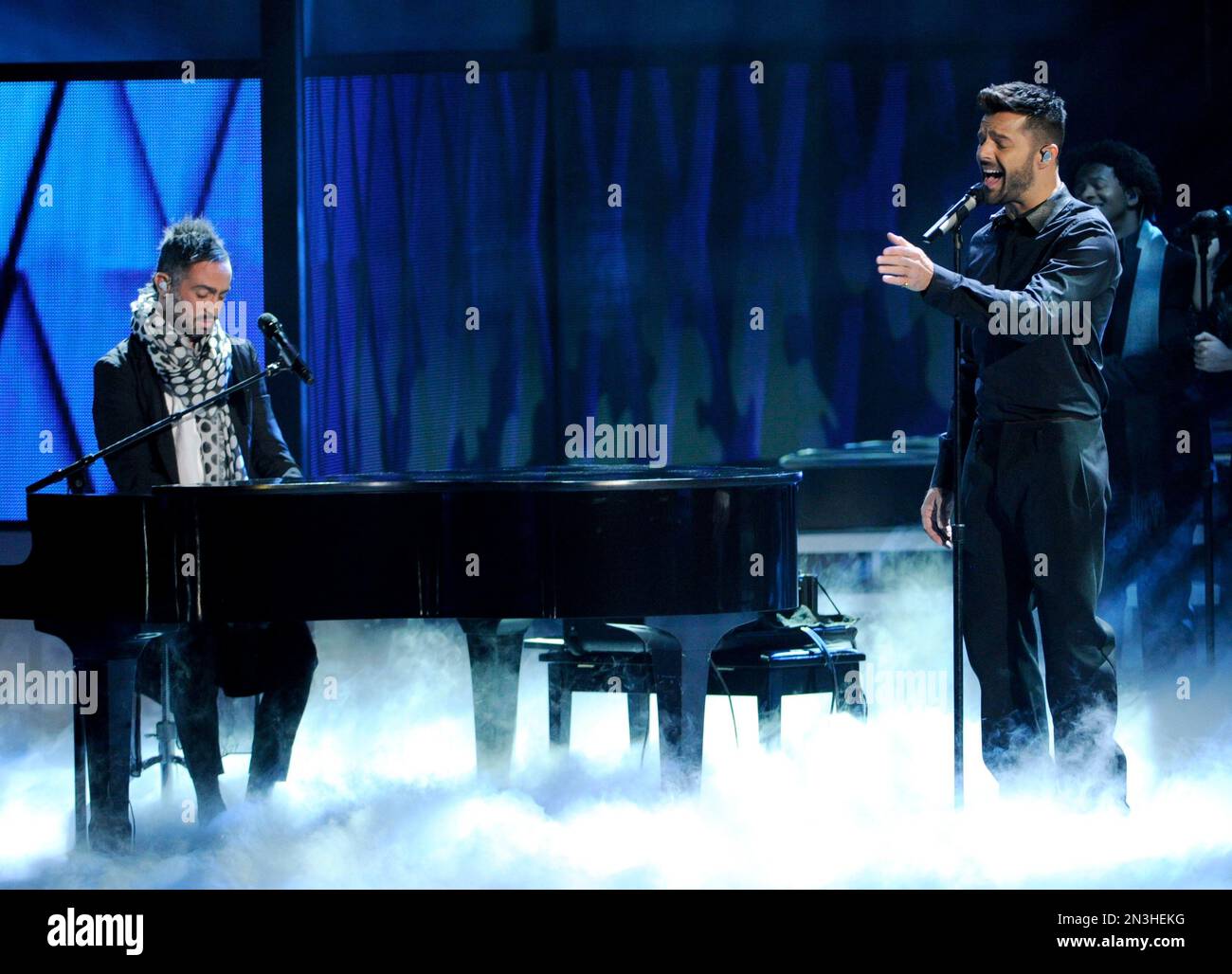 Mario Domm, of the musical group Camila, left, and Ricky Martin perform ...