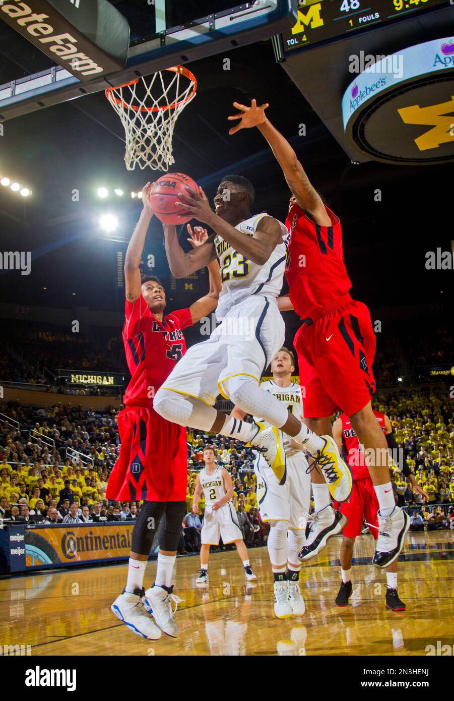 Michigan guard Caris LeVert (23) gets double-teamed under the basket in ...