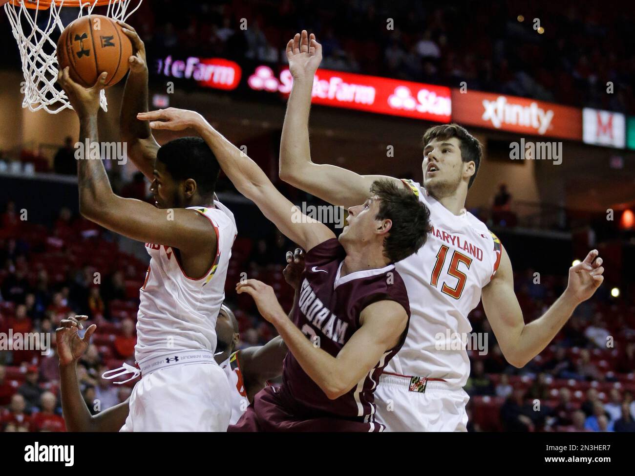 Maryland guard Dion Wiley, left, grabs a rebound in front of Fordham ...