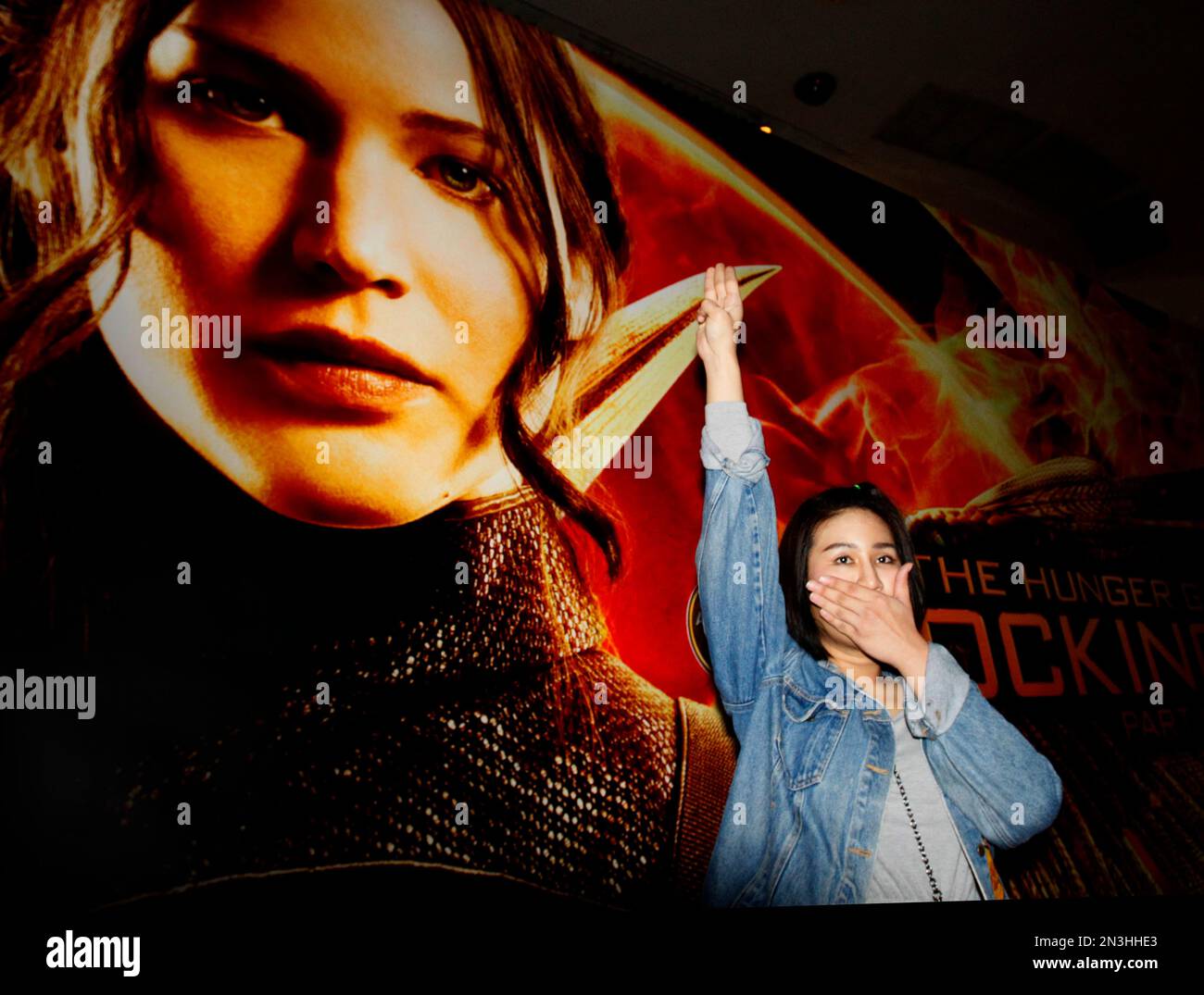 Nachacha Kongudom, 21, raises a three-finger salute outside a cinema ...