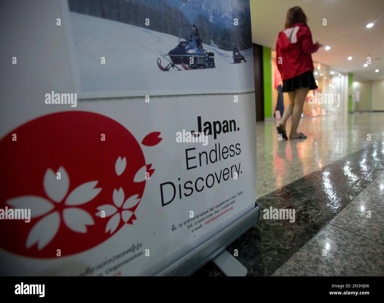 In this Nov. 19, 2014 photo, a Thai woman walks in front of a billboard ...