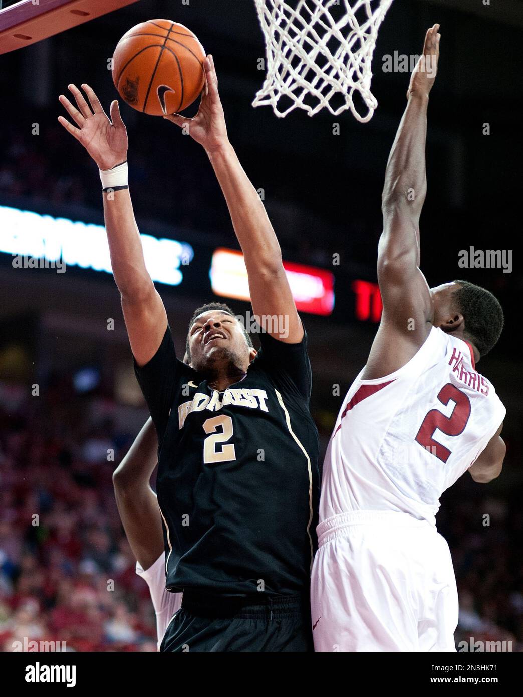Wake Forest's Devin Thomas (2) shoots as Arkansas' Alandise Harris (2 ...