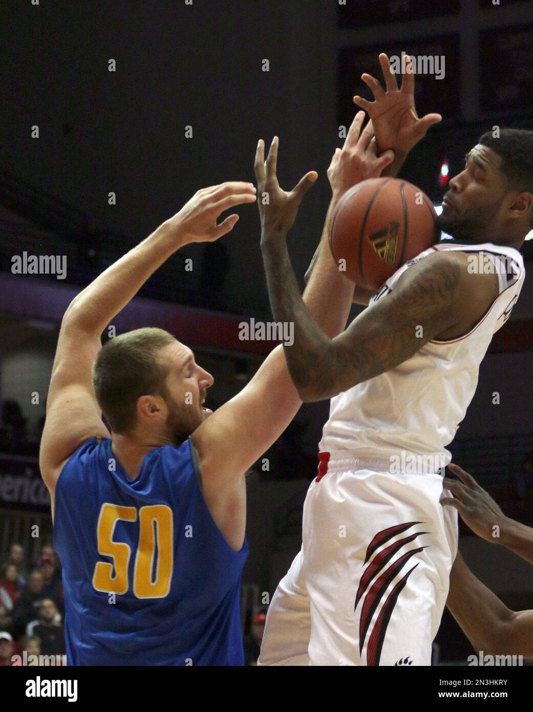 Cincinnati's Octavius Ellis, right, pulls a rebound away from Morehead ...