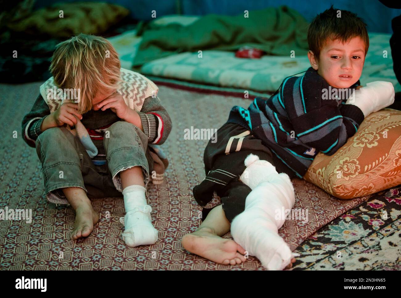 Mahmut Munir, 8 years-old, right, a Syrian Kurdish refugee boy from ...