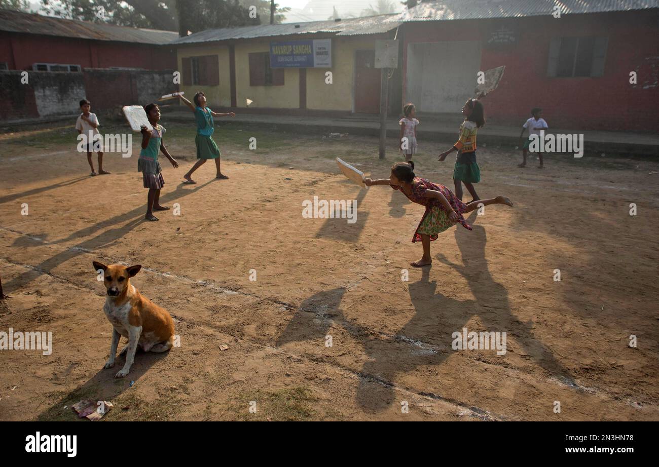 Indian school children play badminton using thermocol sheets in place ...