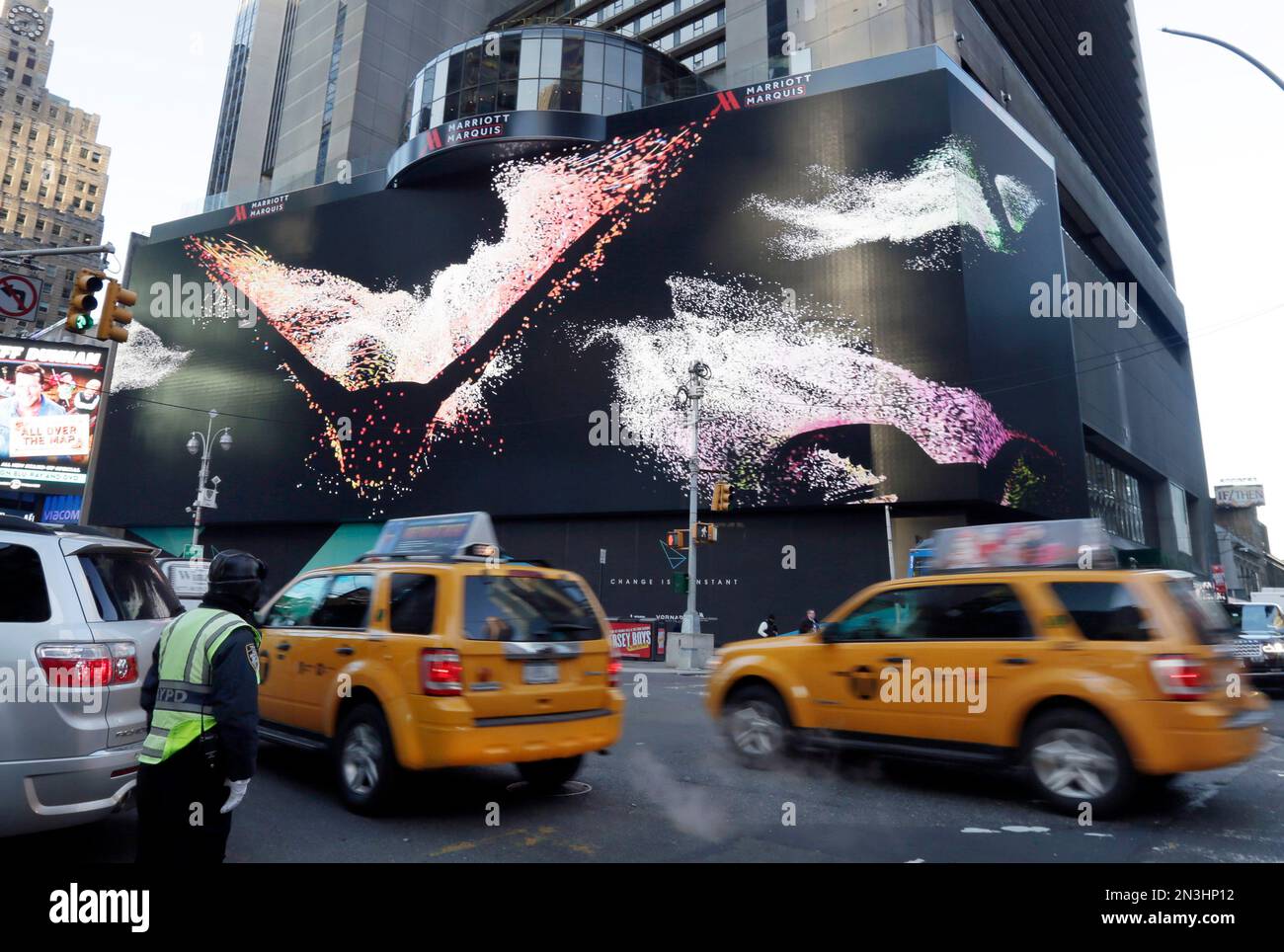 Traffic passes the giant animated billboard on the facade of the ...