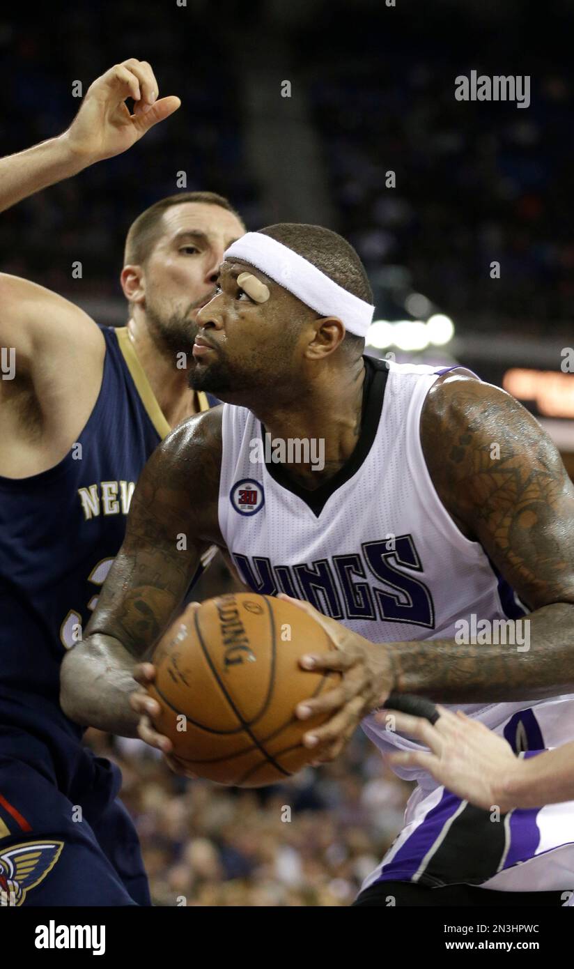 Sacramento Kings center DeMarcus Cousins, right, goes to the basket ...